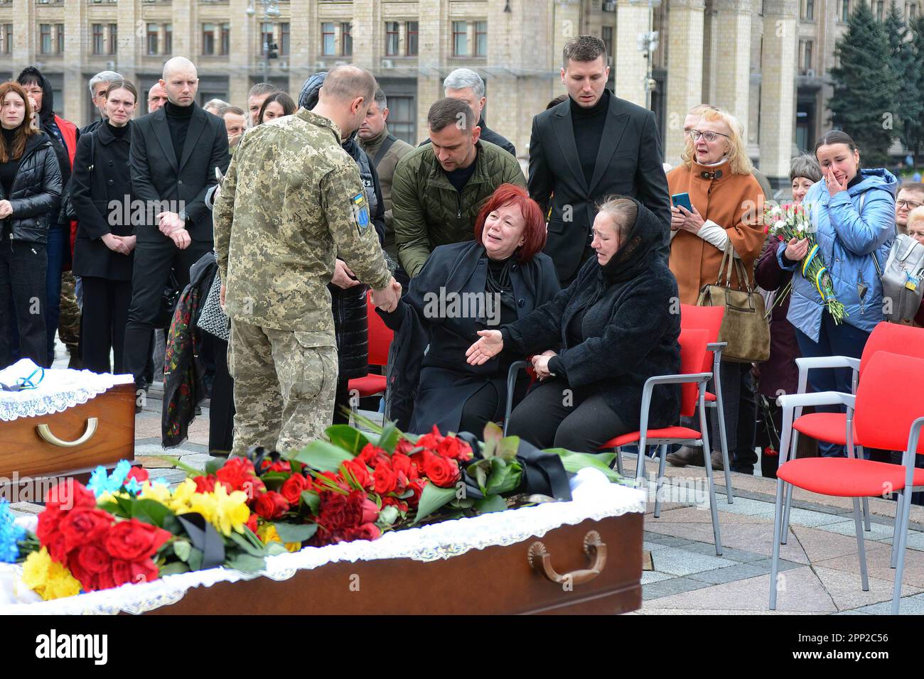 A woman surrounded by people cries during the farewell ceremony for ex ...
