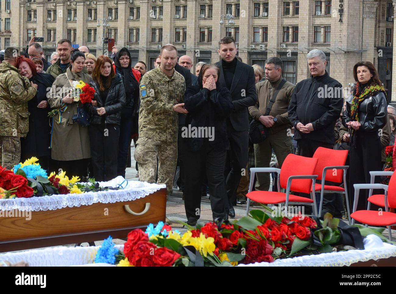 A woman surrounded by people cries during the farewell ceremony for ex ...