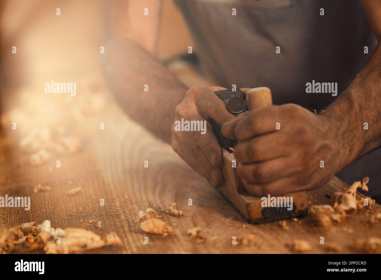 The wood artisan, a robust and strong man known as a carpenter, hand ...
