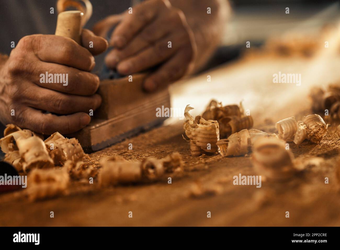 The wood artisan, a robust and strong man known as a carpenter, hand ...