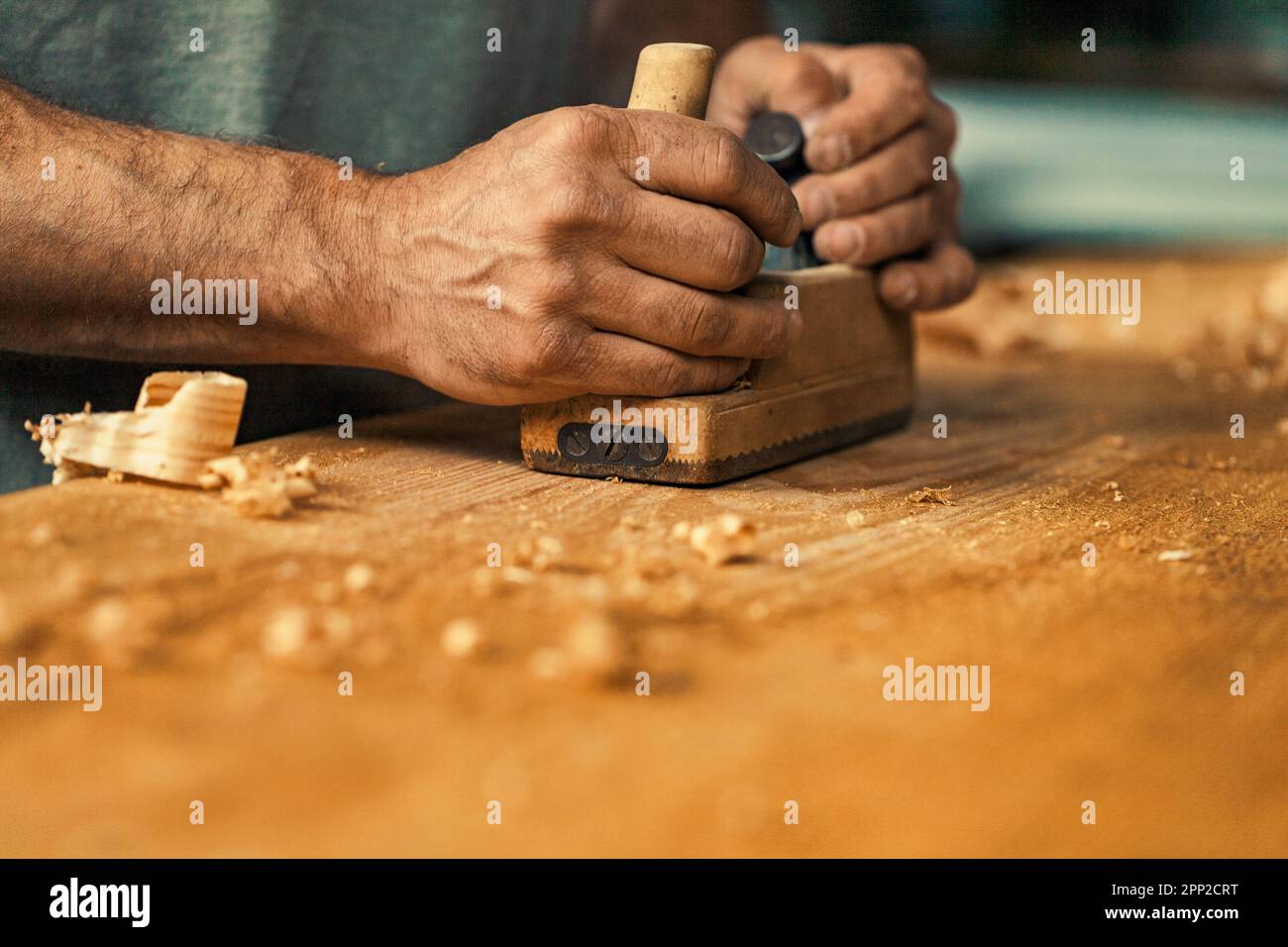 The wood artisan, a robust and strong man known as a carpenter, hand ...