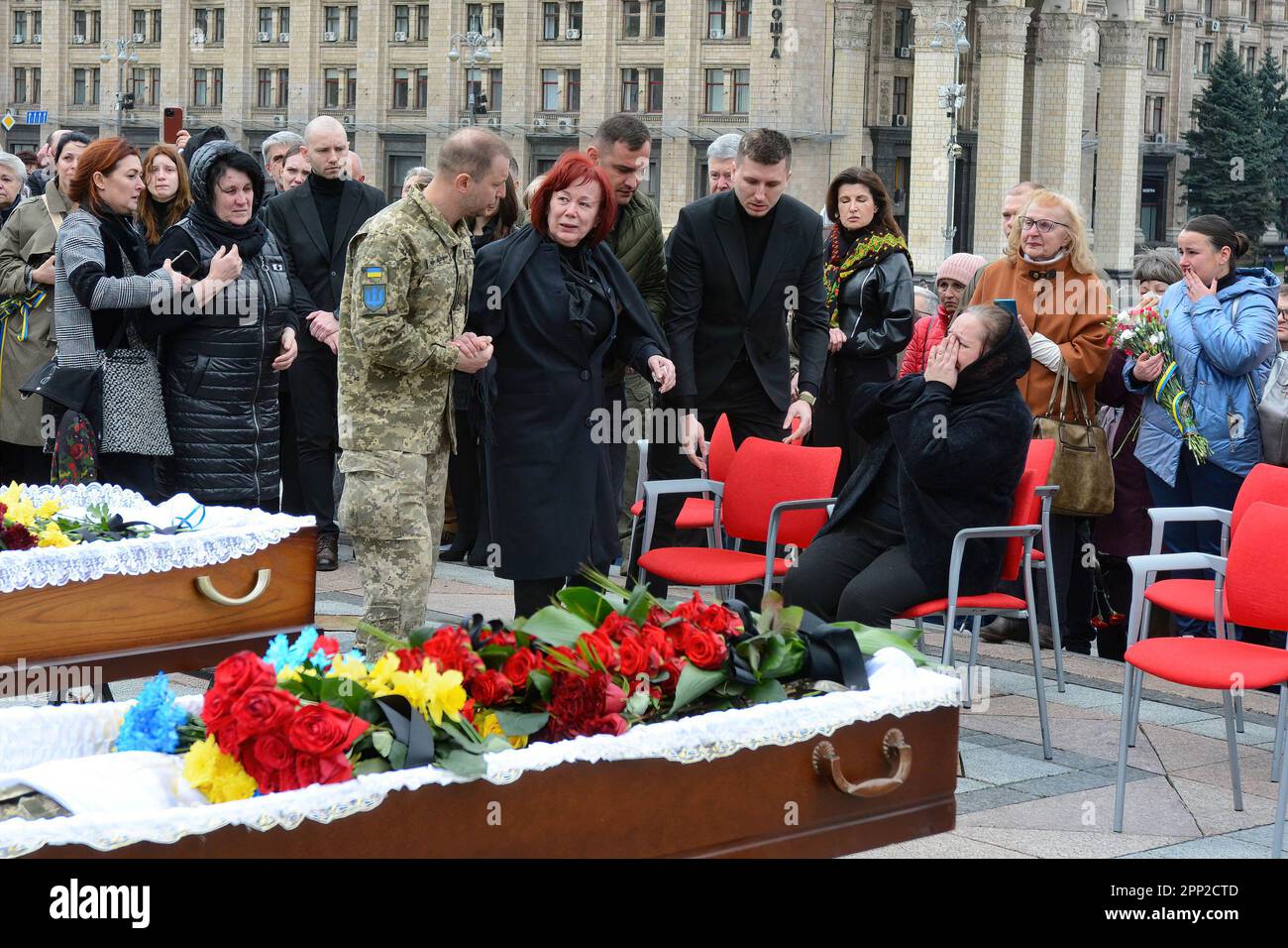 A woman surrounded by people cries during the farewell ceremony for ex ...