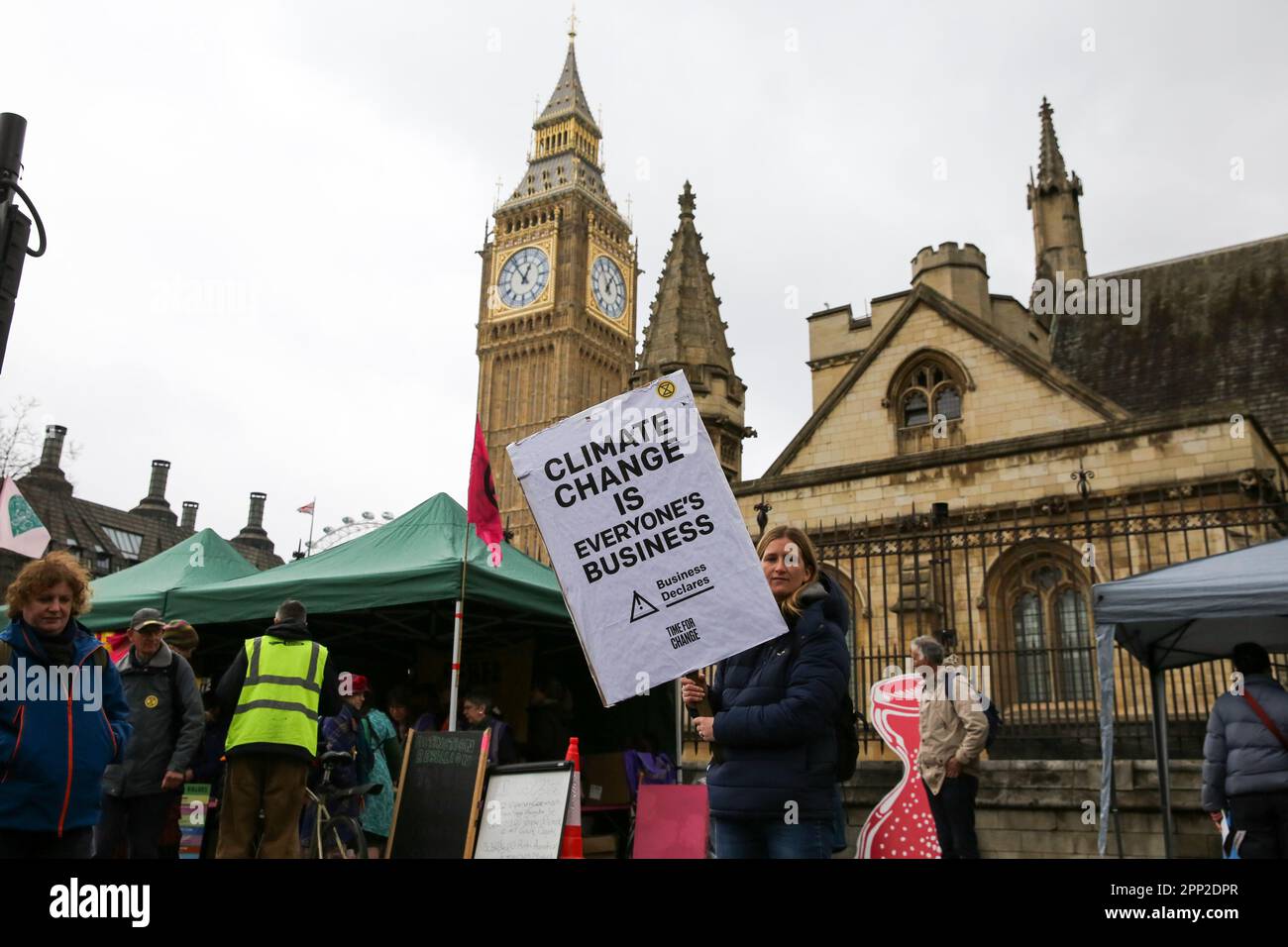 London, UK. 21st Apr, 2023. A member of Extinction Rebellion holds a ...
