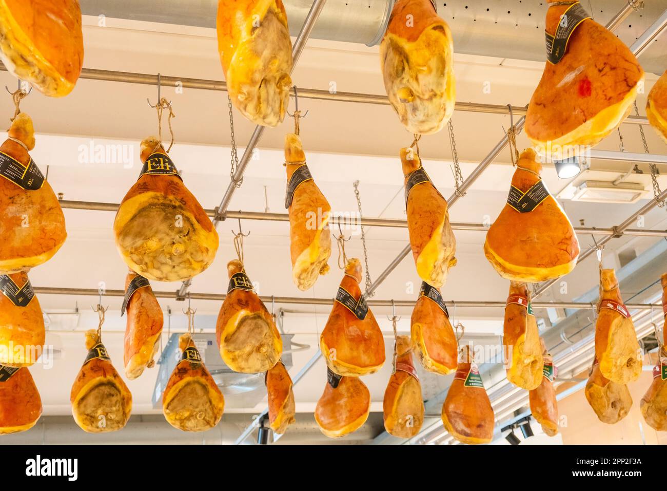 Jamon or leg of SErrano ham hanging from the ceiling in a supermarket ...