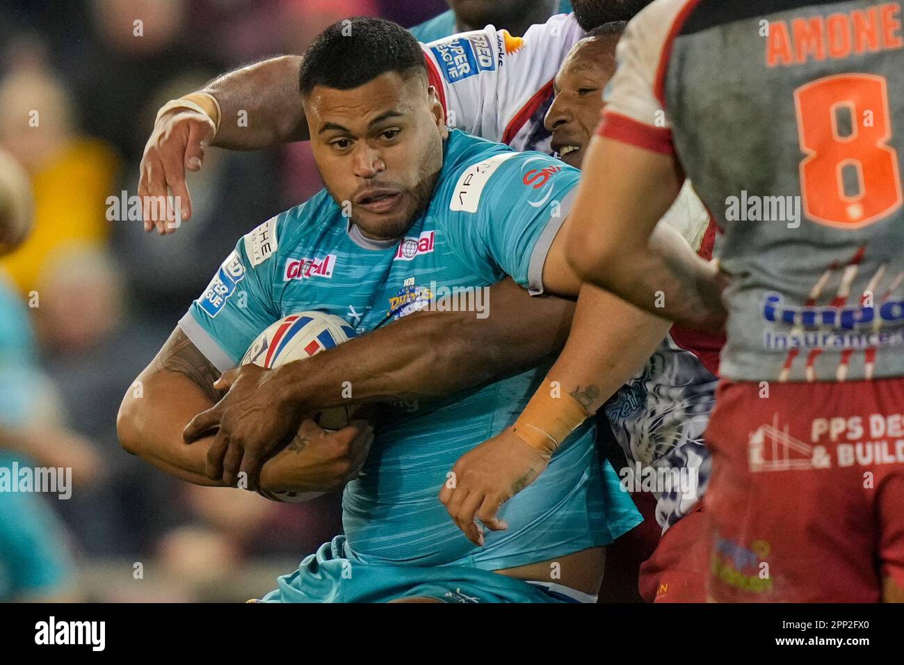 Sam Lisone #15 of Leeds Rhinos runs at the Leigh Leopards defence ...