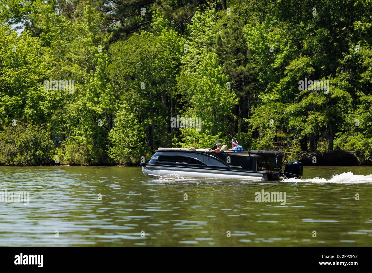 Boaters on pontoon boat enjoy summer day on Lake. Pontoon party boat ...