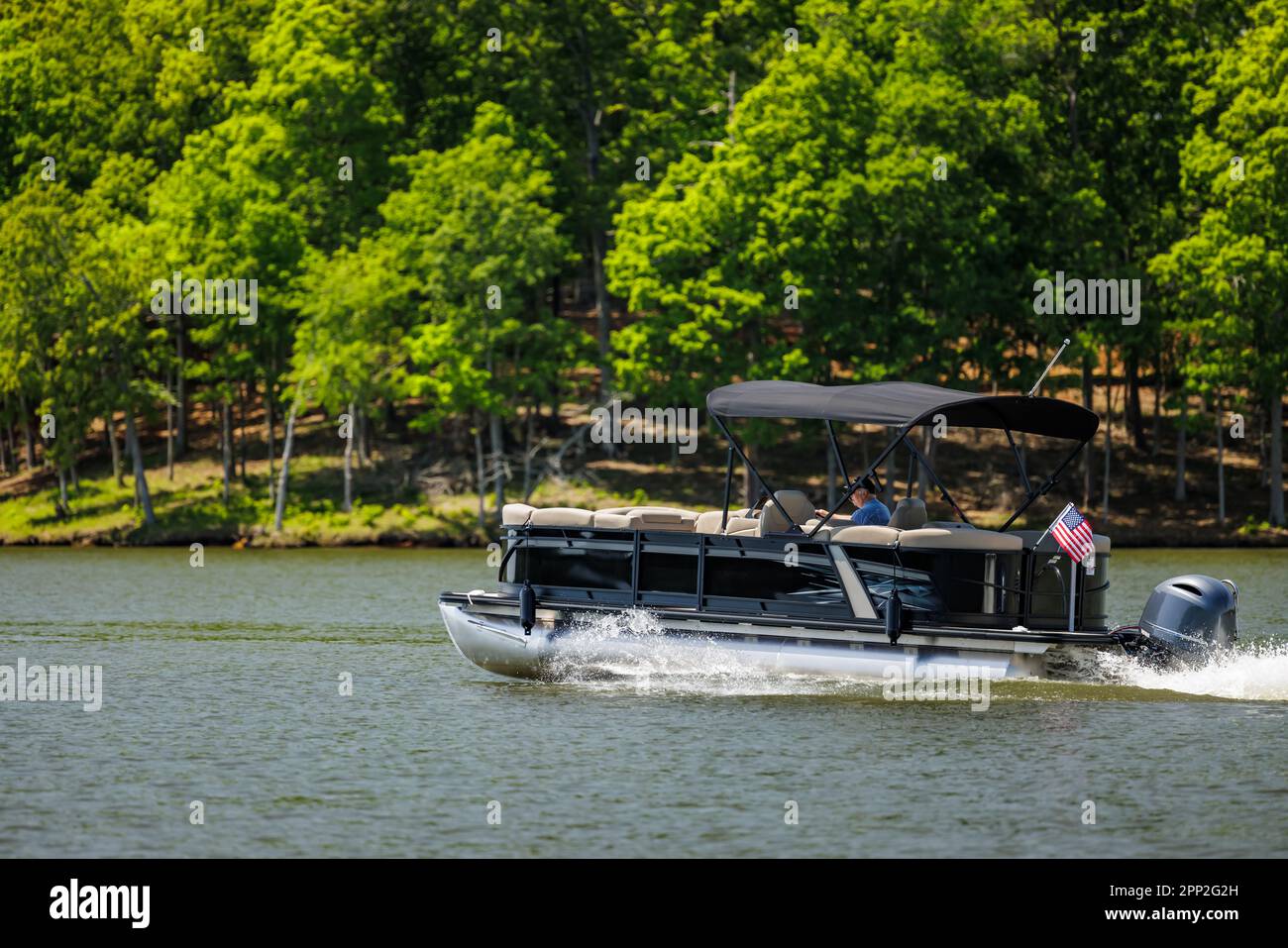 Boater on pontoon boat enjoying summer day on Lake. Pontoon party boat ...