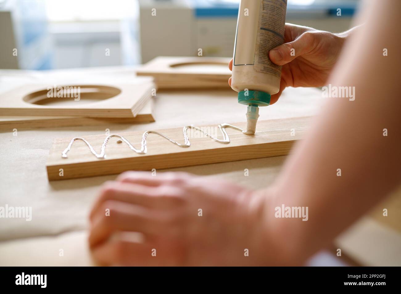 Closeup carpenter applying glue to board wooden timbers Stock Photo - Alamy