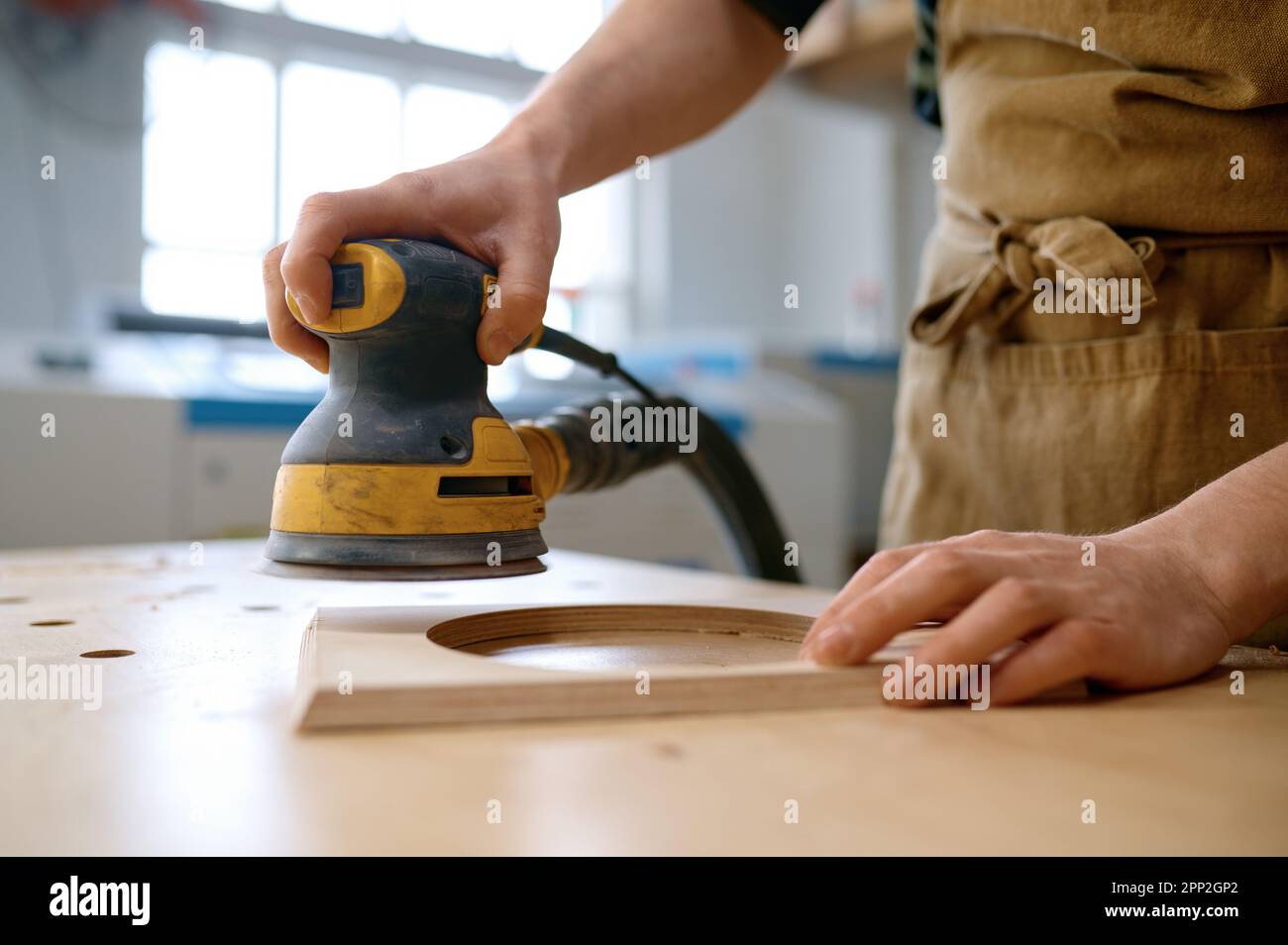 Closeup craftsman hands working with eccentric grinding machine Stock ...