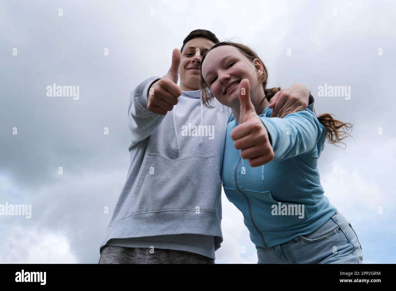 against the backdrop stormy cloudy sky boys teenage girls lean over ...