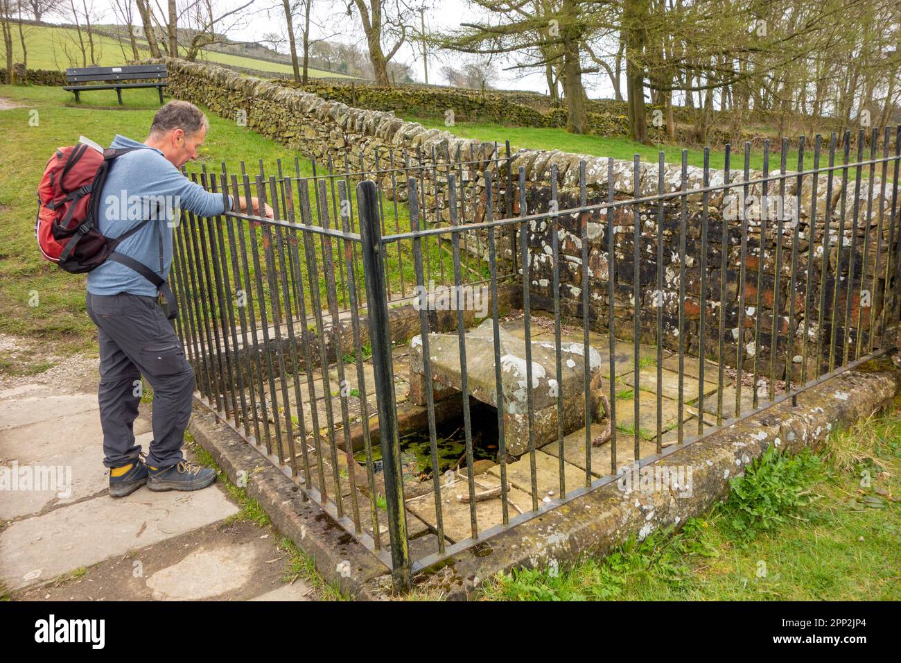 Man walking backpacking in the Peak District stopped to look at ...