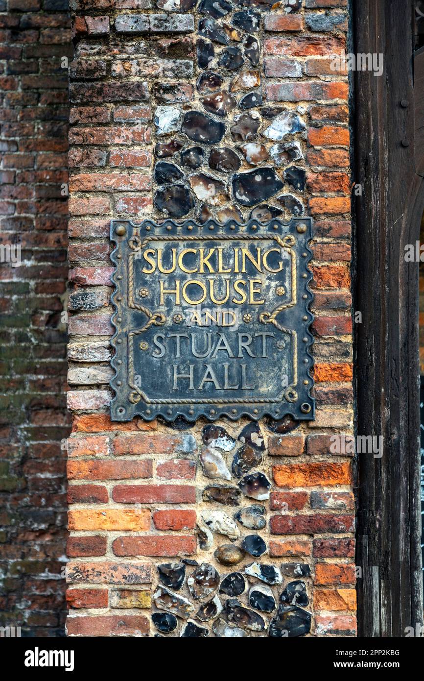 Sign on historic medieval flint and brick Stuart Hall and Suckling ...