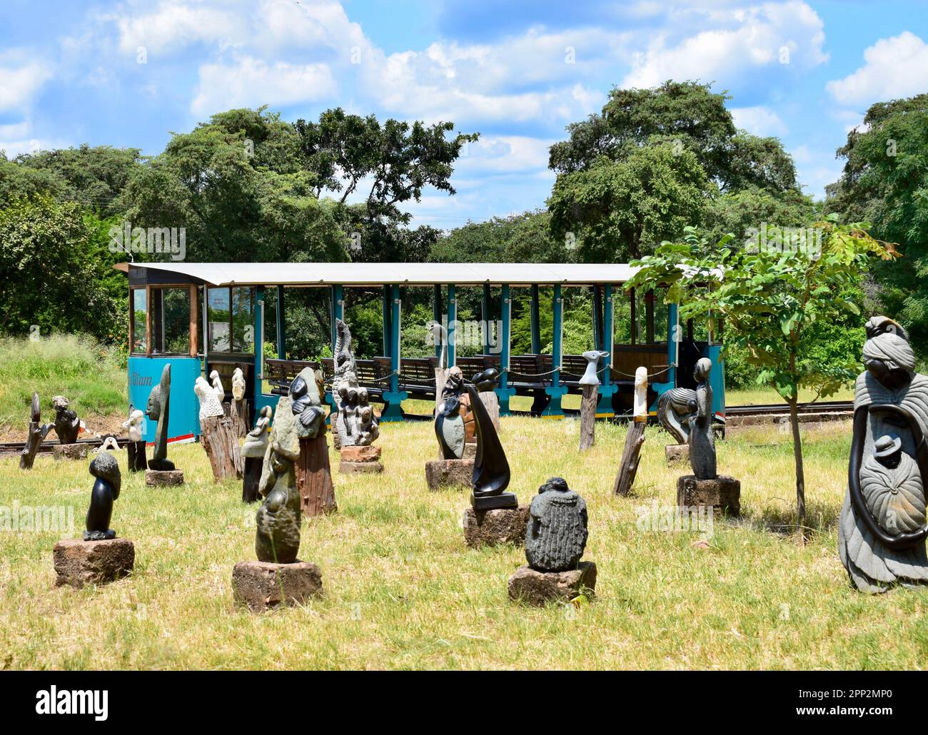 Stone sculptures sold outdoors with Bam Bam train in the background ...