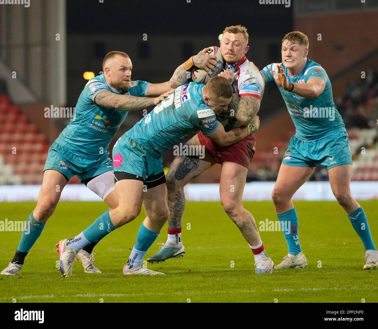 Josh Charnley #5 of Leigh Leopards is tackled by Harry Newman #3 of ...