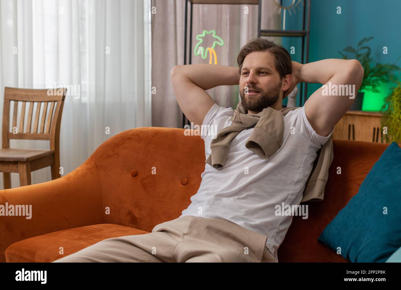 Tired man lying down on comfortable couch, taking a rest, daytime nap ...