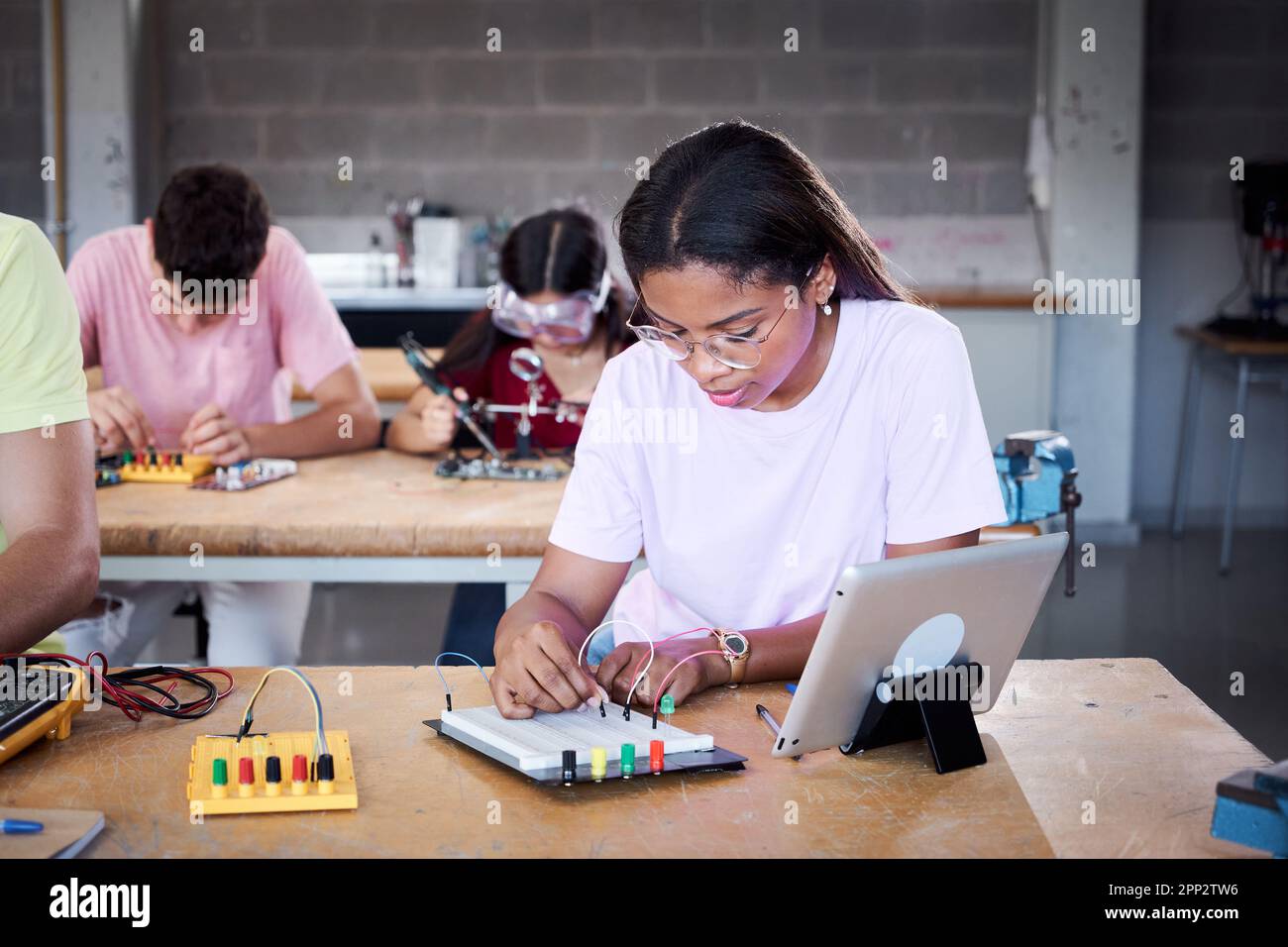 Young Latin girl student at technical high school in classroom hardware ...