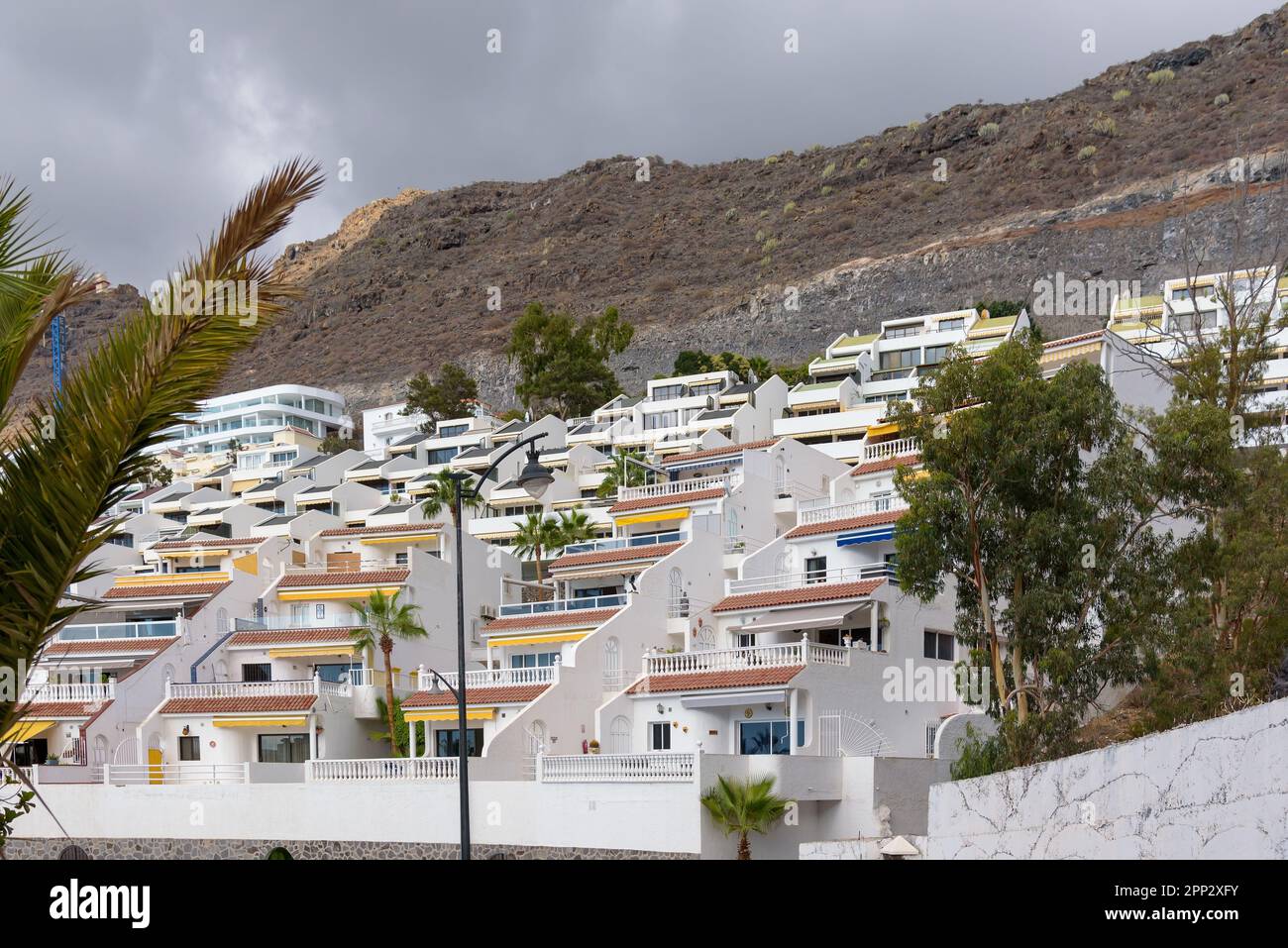 Residential buildings at the foot of the cliff in Los Gigantes on ...