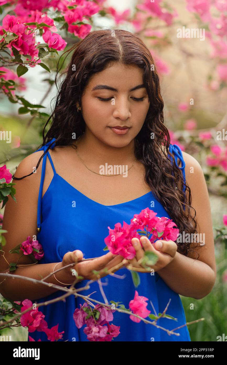 female portrait session in the field surrounded by flowers and lots of ...