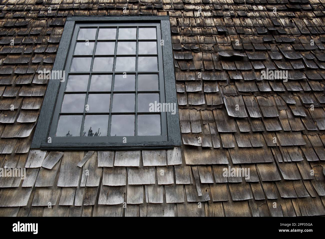 Old Rhode Island barn with wooden shingles and one window with green ...