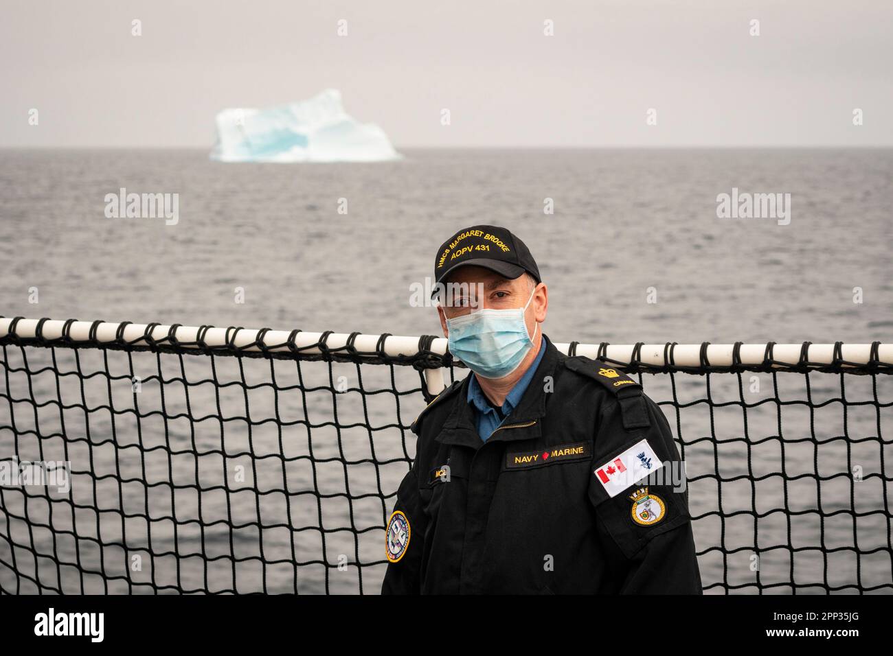 RCN sailor onboard HMCS Margaret Brooke poses in front of an iceberg in ...