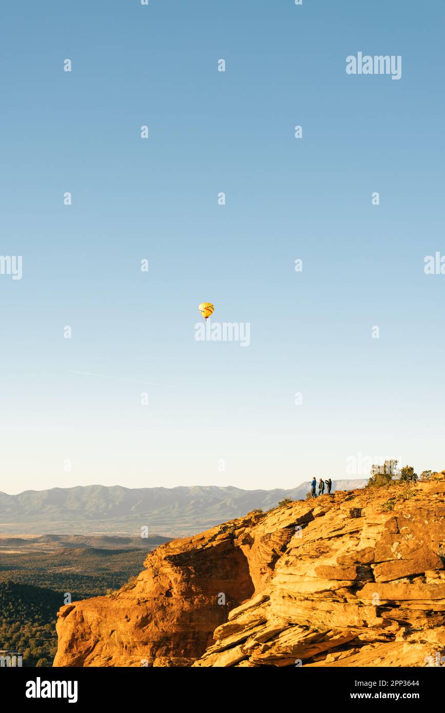 Three people observe hot air balloon in sky in Sedona Arizona Stock ...