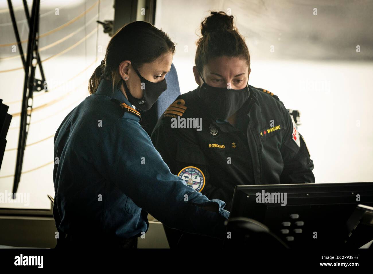 Commanding Officer (CDR Nicole Robichaud) and officer confer on the ...