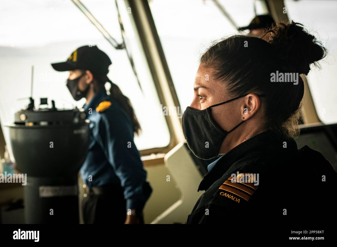 Commanding Officer and officer confer on the bridge of HMCS Margaret ...
