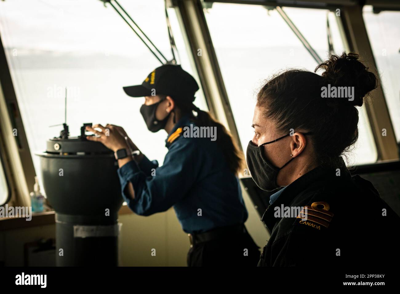 Commanding Officer (CDR Nicole Robichaud) and officer confer on the ...