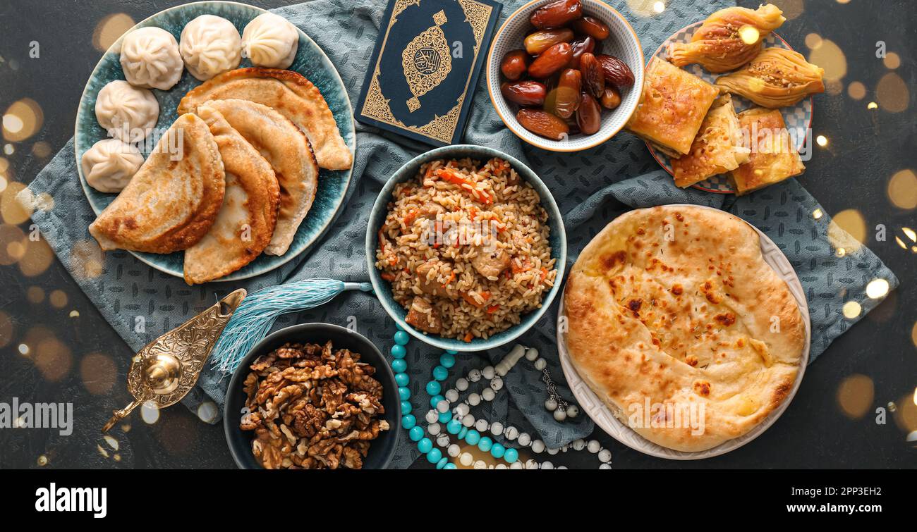 Traditional Eastern dishes with Quran book on dark background Stock ...