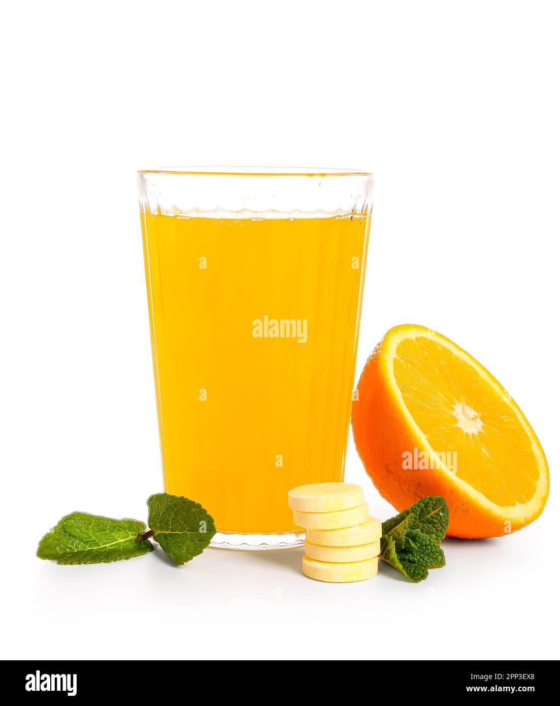 Glass of vitamin C effervescent tablet dissolved in water and orange ...