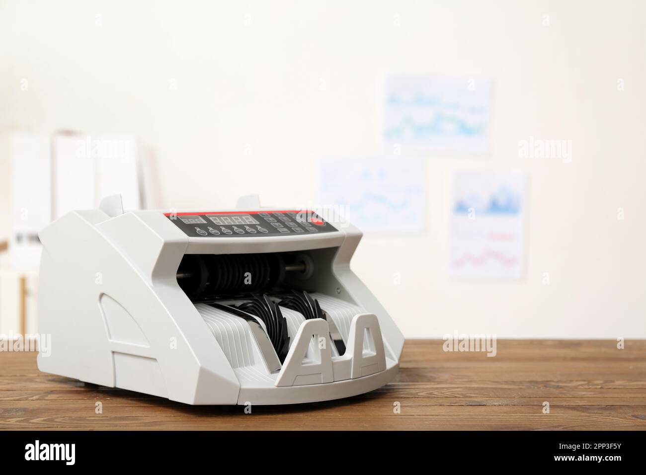 Modern cash counting machine on table in office Stock Photo - Alamy