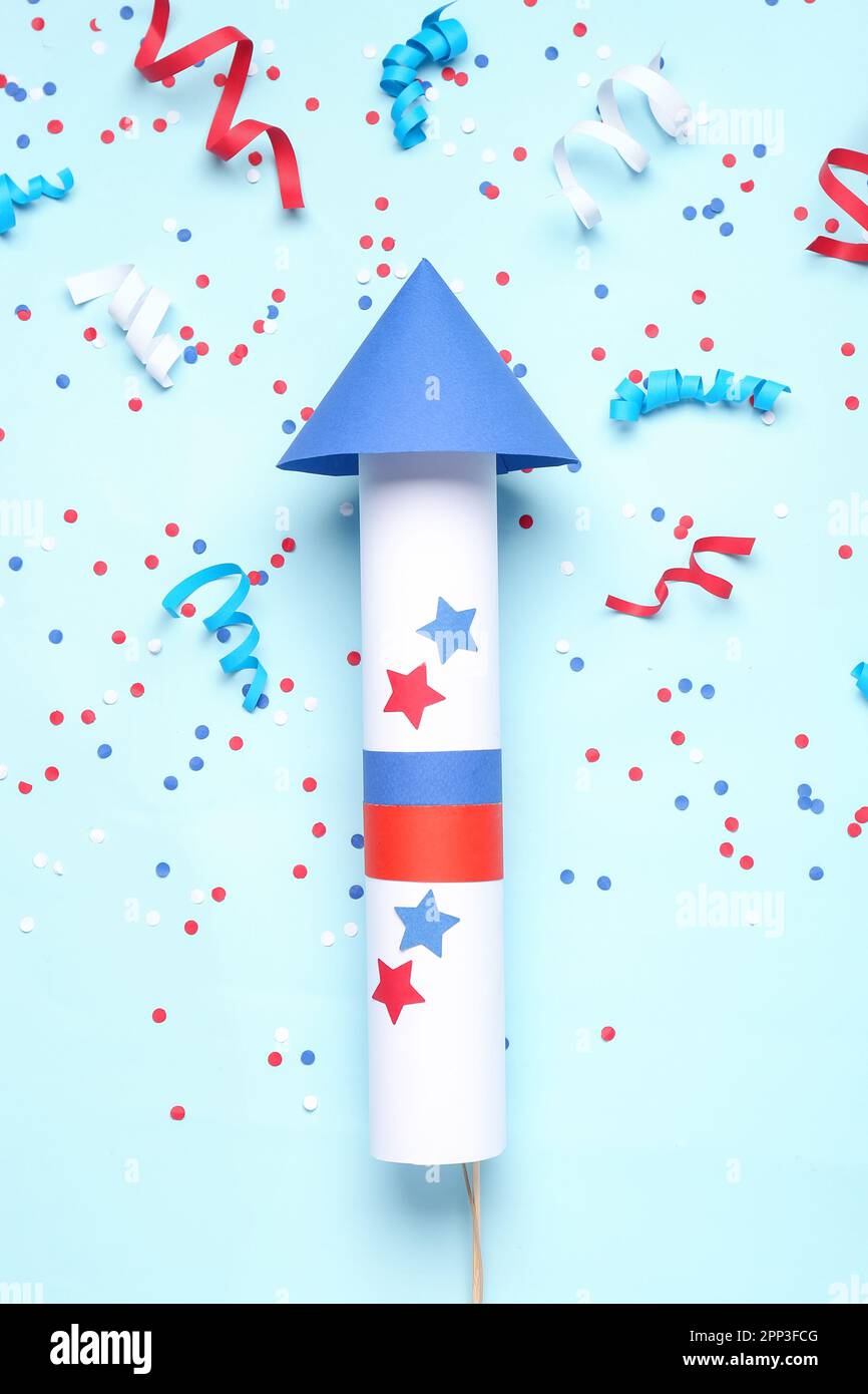 Firework rocket, confetti and serpentine for Independence Day on blue ...