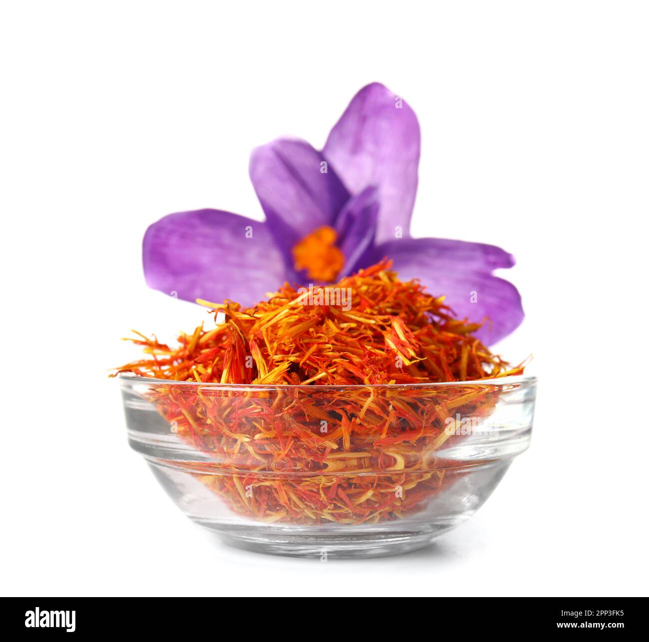 Bowl of dried saffron threads and crocus flower isolated on white ...