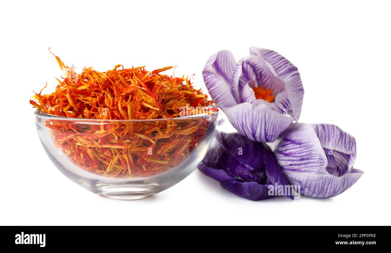 Bowl of dried saffron threads and crocus flowers isolated on white ...