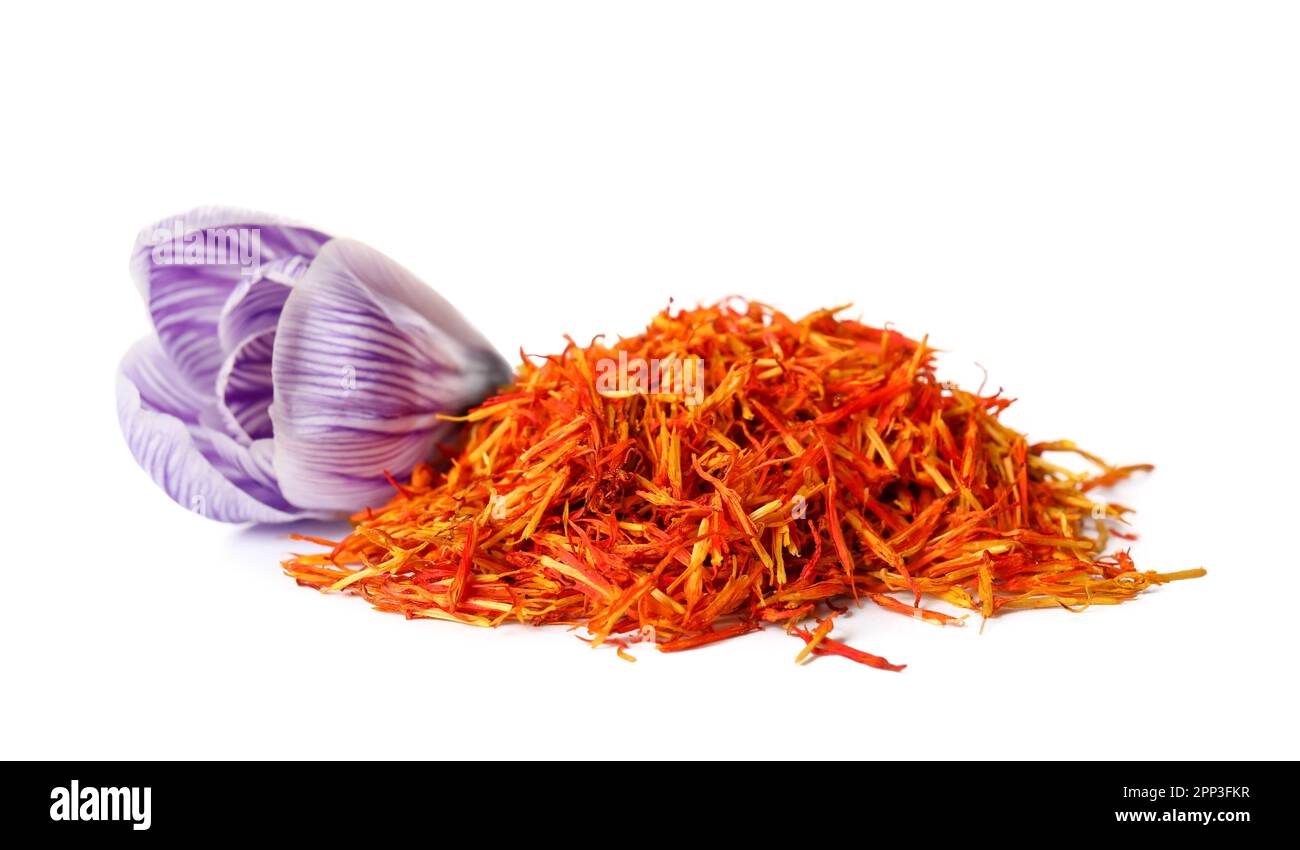 Heap of dried saffron threads and crocus flower isolated on white ...