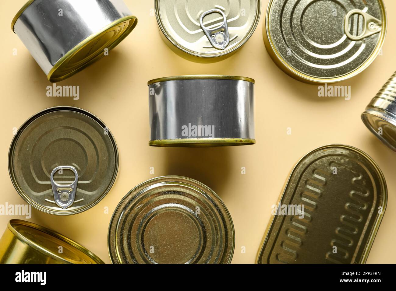Tin cans with fish on beige background Stock Photo - Alamy