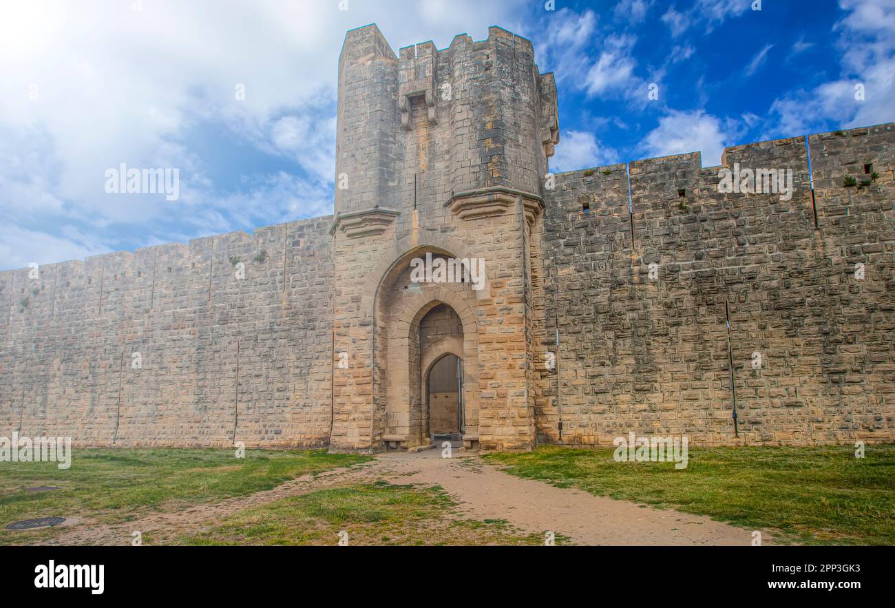 Stone wall of european castle with gate in soft sunlight Stock Photo ...