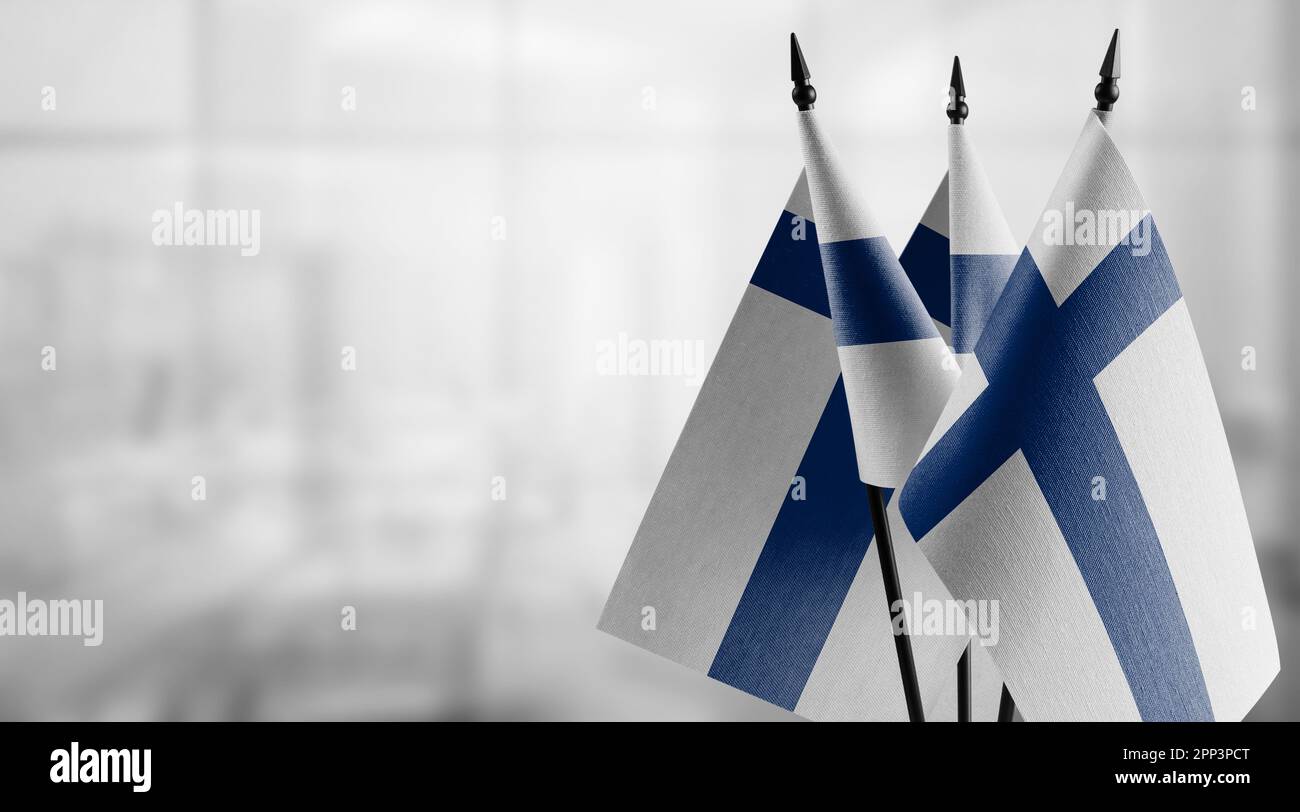 Small flags of the Finland on an abstract blurry background Stock Photo ...