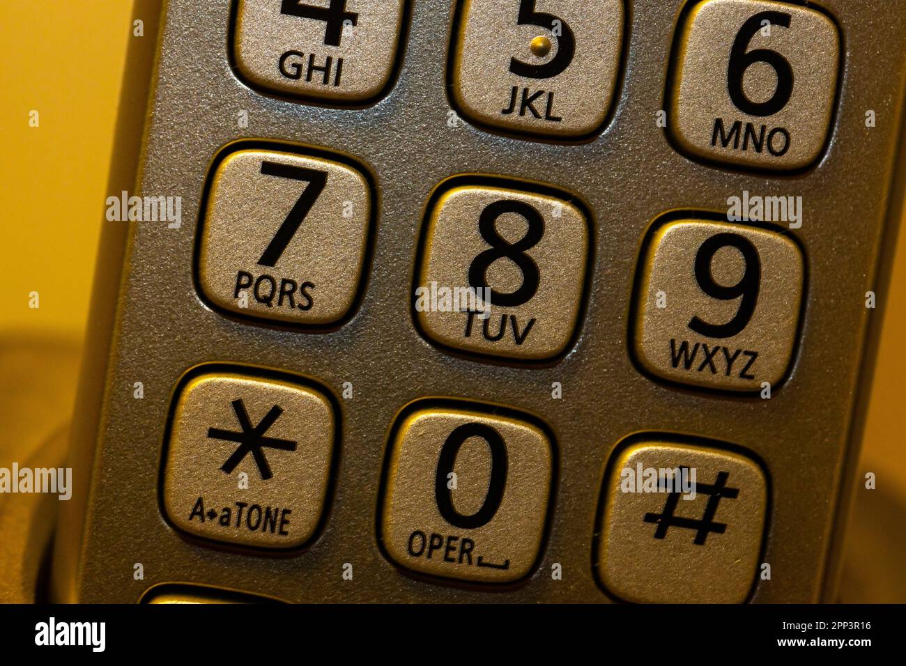 Close up view of a silver tone cordless push button telephone receiver ...