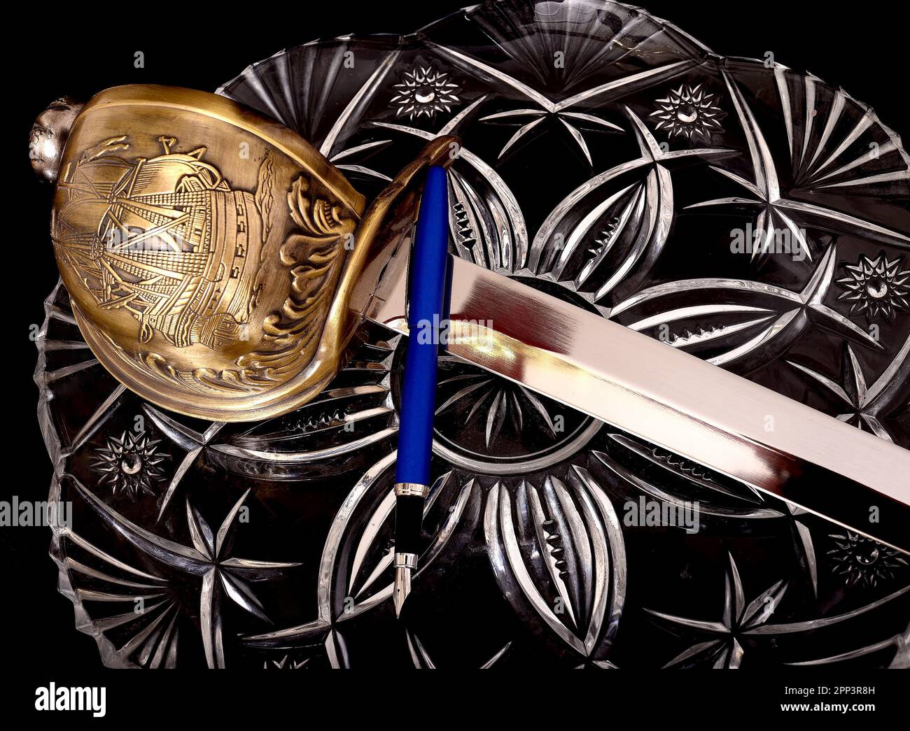 Medieval Sword and pen isolated over a black background Stock Photo - Alamy
