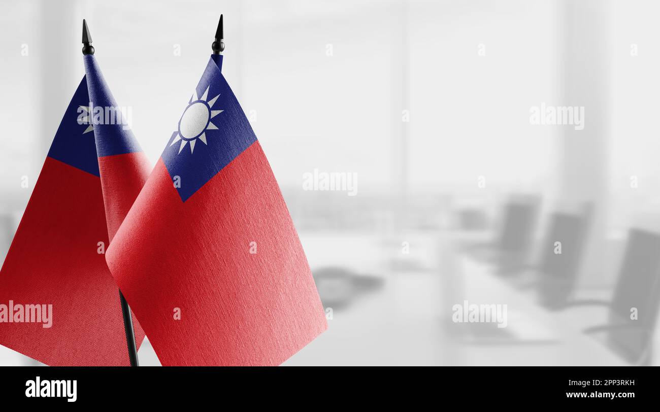 Small flags of the Taiwan on an abstract blurry background Stock Photo ...