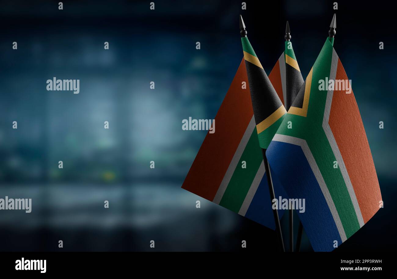 Small flags of the South Africa on an abstract blurry background Stock ...