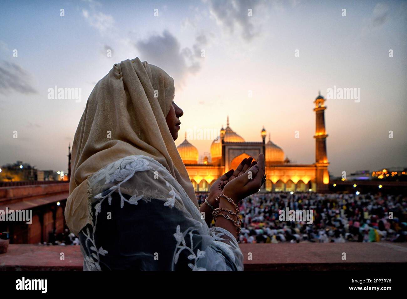 A Muslim woman offers prayers during Iftar time in the ongoing Holy ...