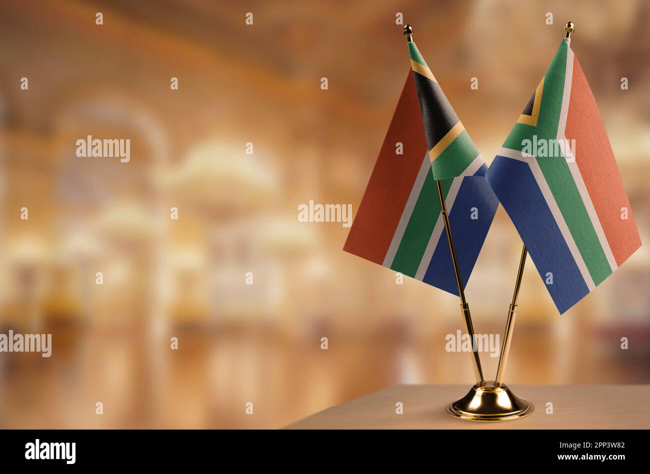 Small flags of the South Africa on an abstract blurry background Stock ...