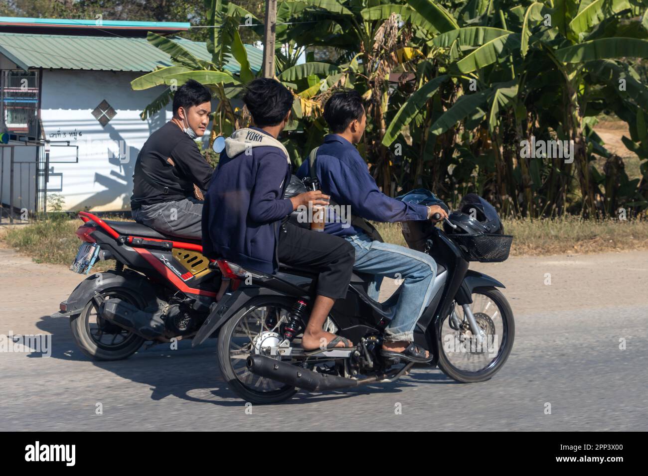 BANGKOK, THAILAND, JAN 21 2023, A pair of motorbikes drive side by side ...