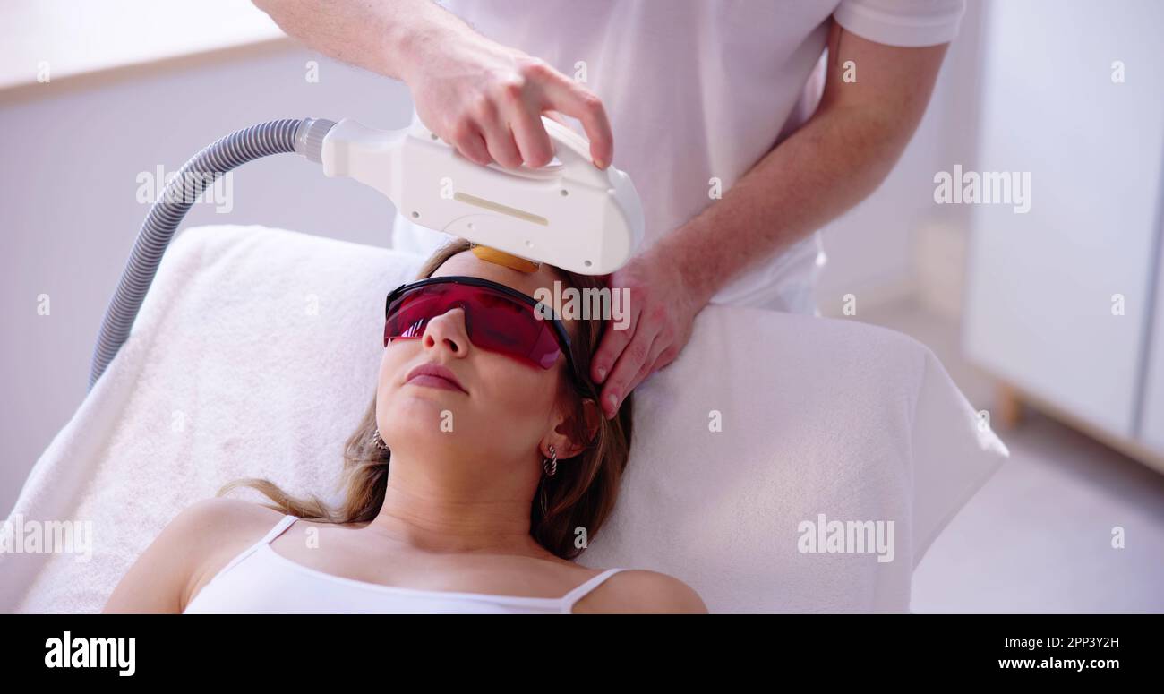 Beautician Giving Epilation Laser Treatment On Woman's Face Stock Photo ...