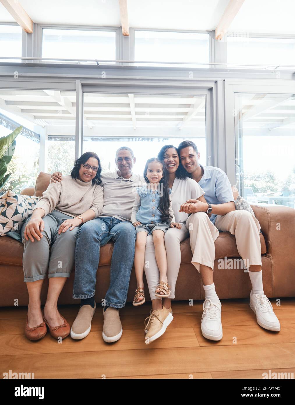 Big family in portrait with parents, grandparents and child on sofa in ...