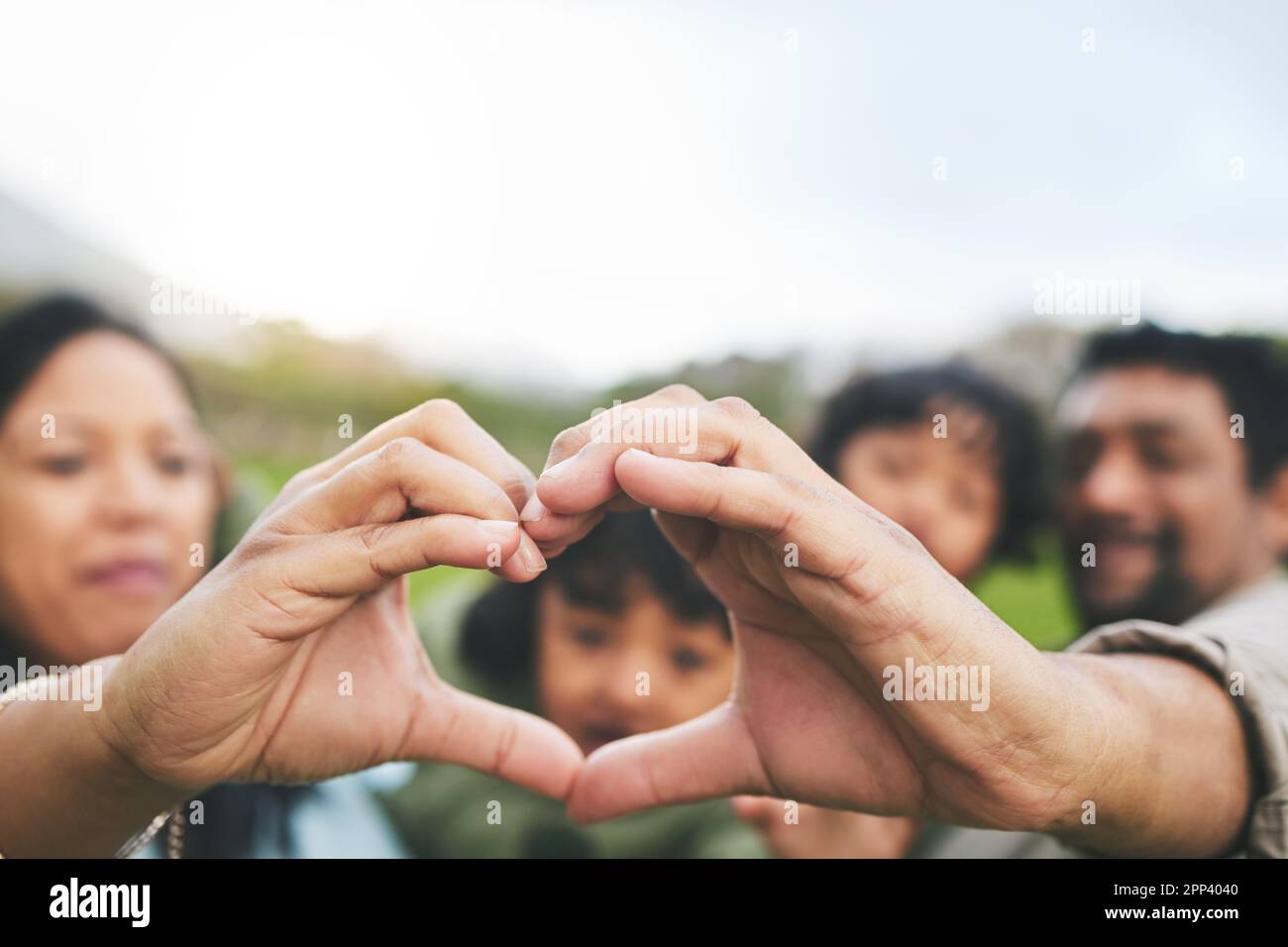Family, heart and hands outdoor in nature for quality time, love and ...
