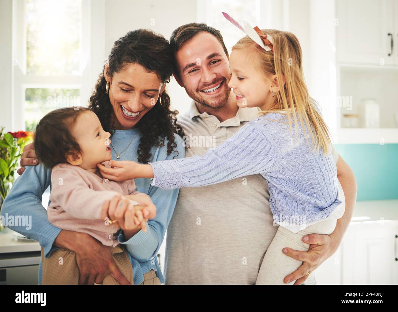 Mother, father and children portrait in a happy family home while ...