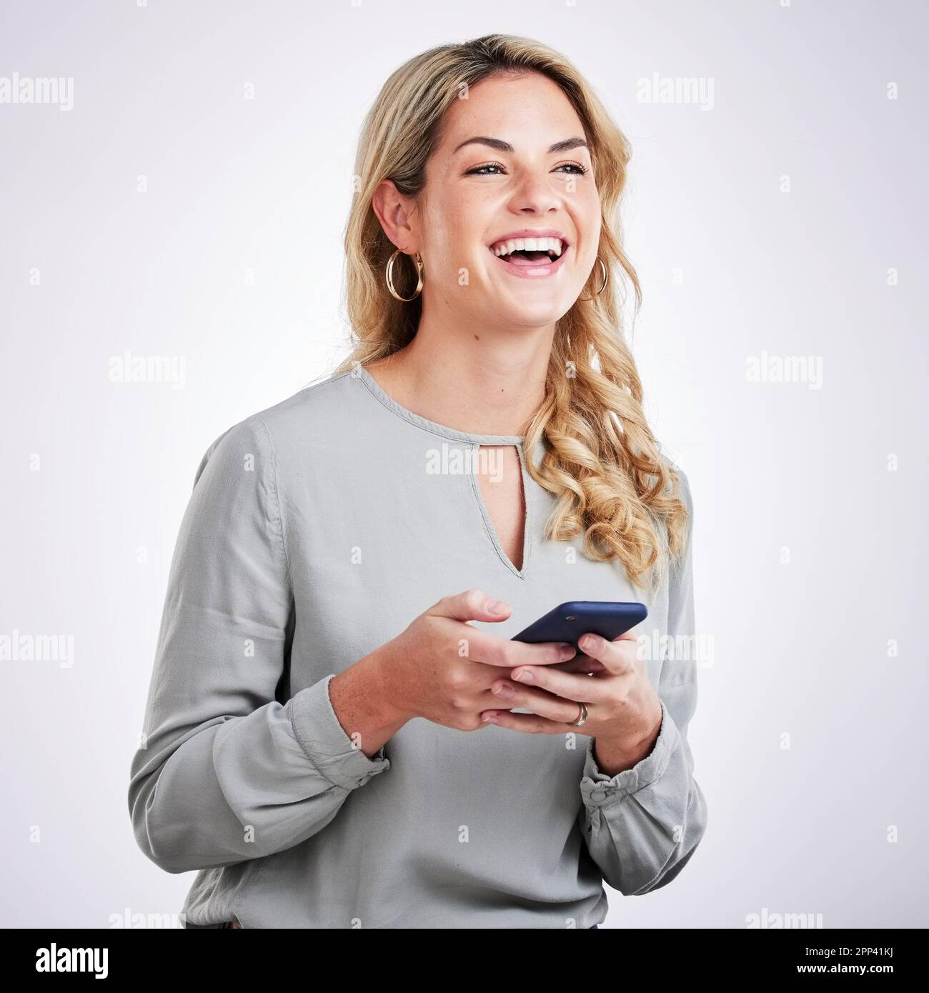Woman, laughing and phone in studio for communication, funny post or ...